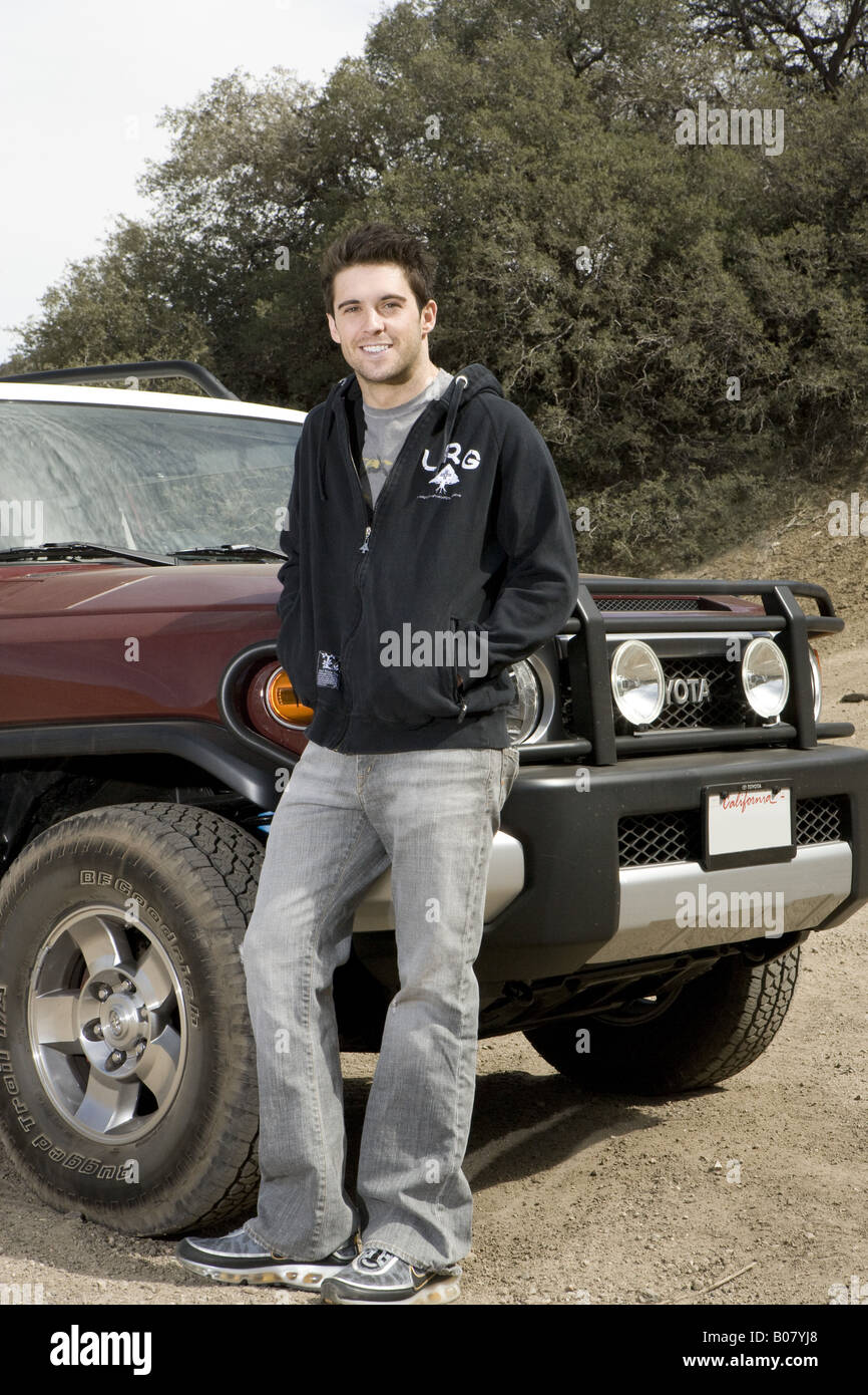 Smiling man with his off-road SUV Stock Photo - Alamy