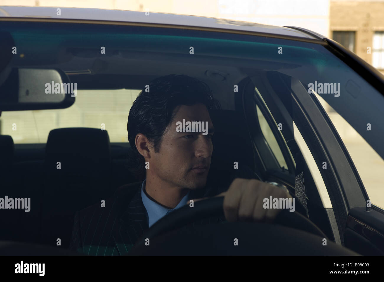 Asian businessman driving his BMW Stock Photo - Alamy