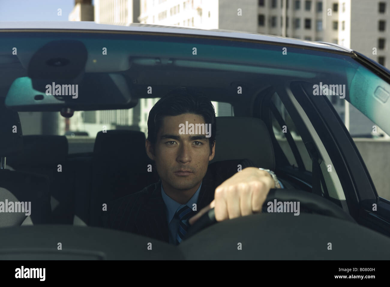 Asian businessman driving his BMW Stock Photo - Alamy