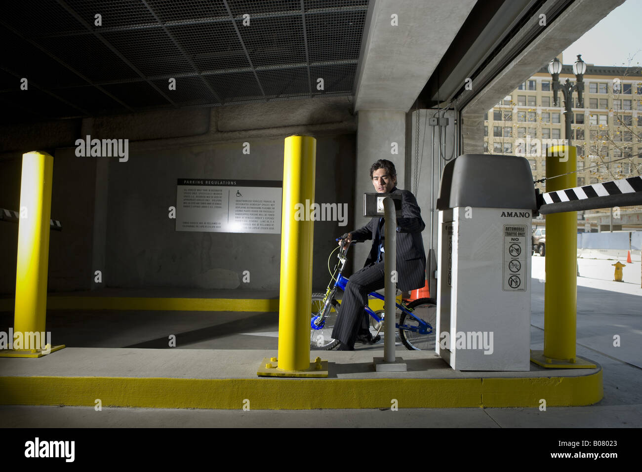 Businessman on bicycle collecting ticket to park Stock Photo - Alamy