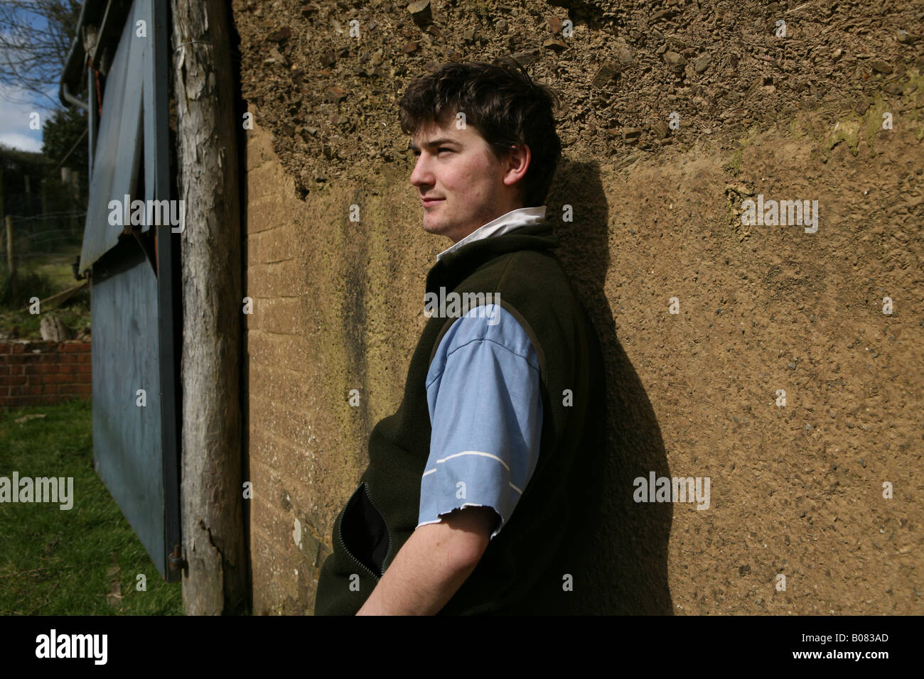 a portrait of a young farmer in a stable on a farm in devon Stock Photo ...