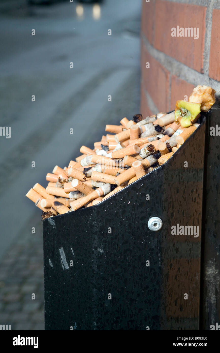 Detail view of an overfilled ashtray outside a public building (The ...