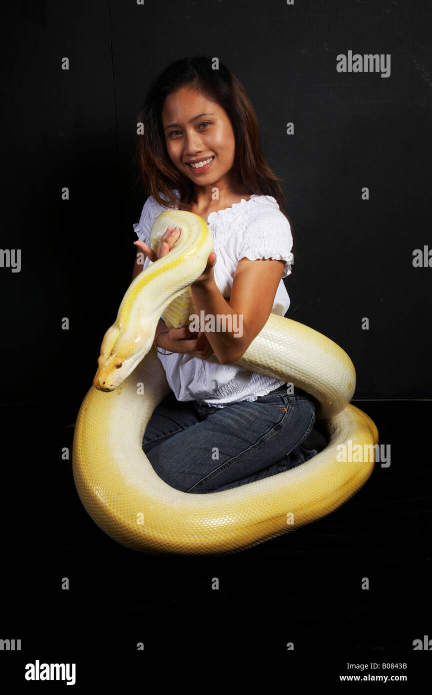 Woman surrounded by huge Albino Python Stock Photo - Alamy