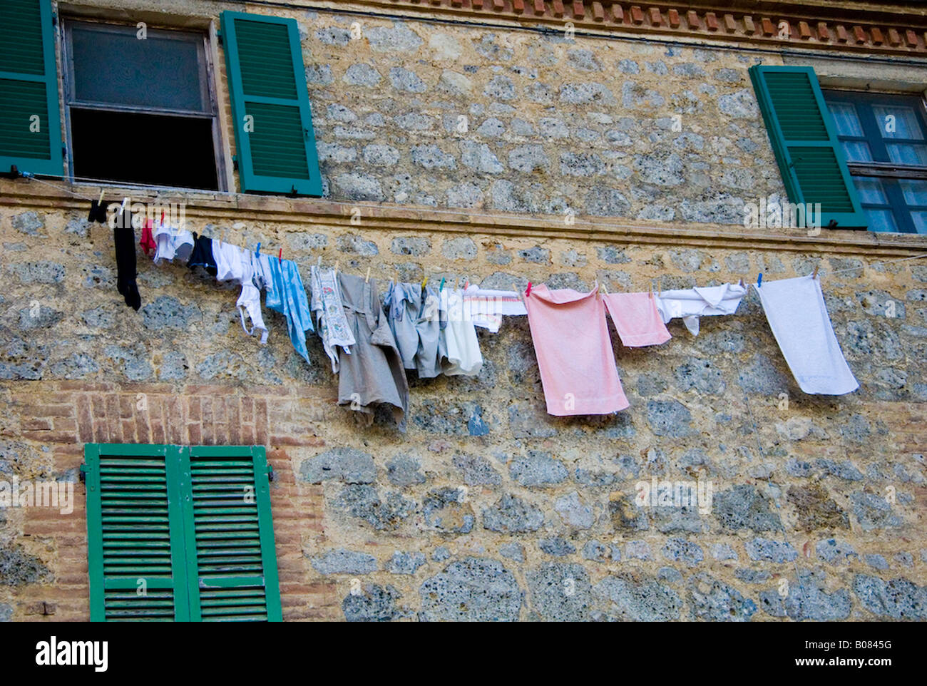 Washing Line against Stone Wall Tuscany Italy Stock Photo - Alamy