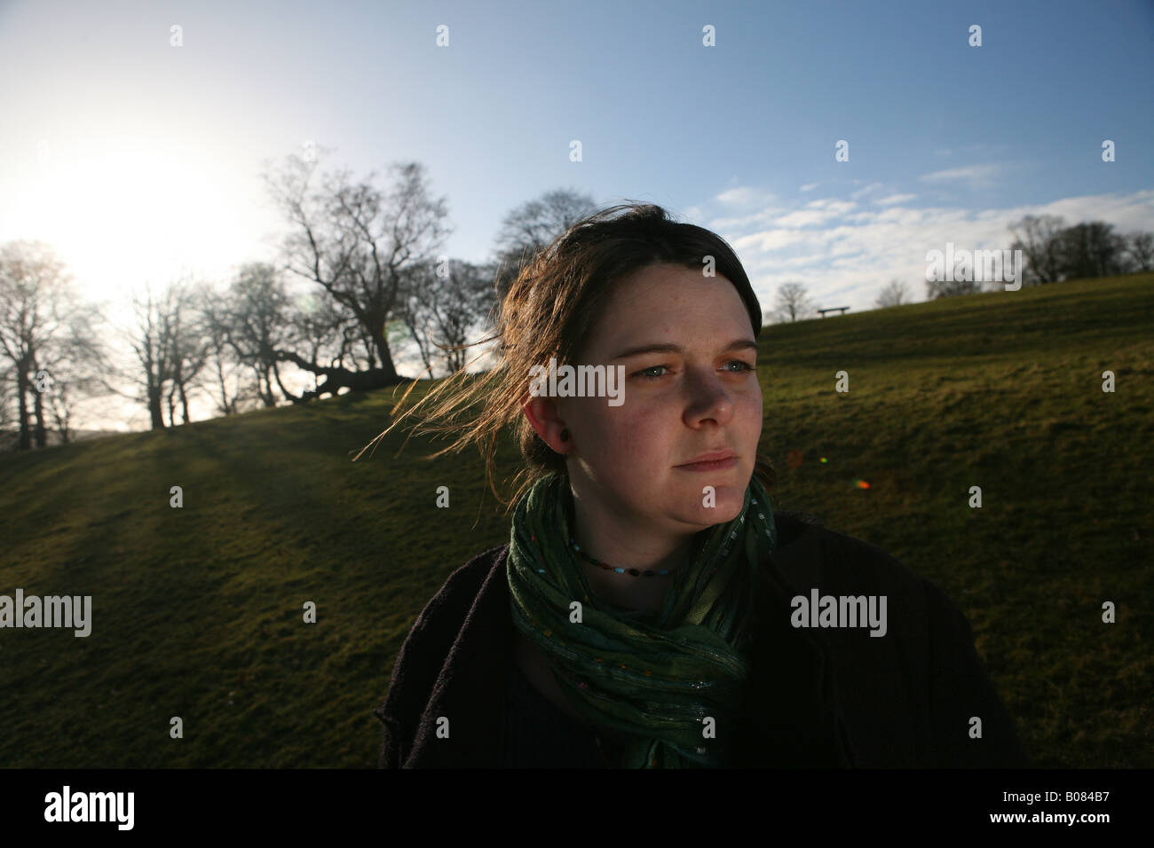 a portrait of a beautiful woman looking off camera with the camera ...