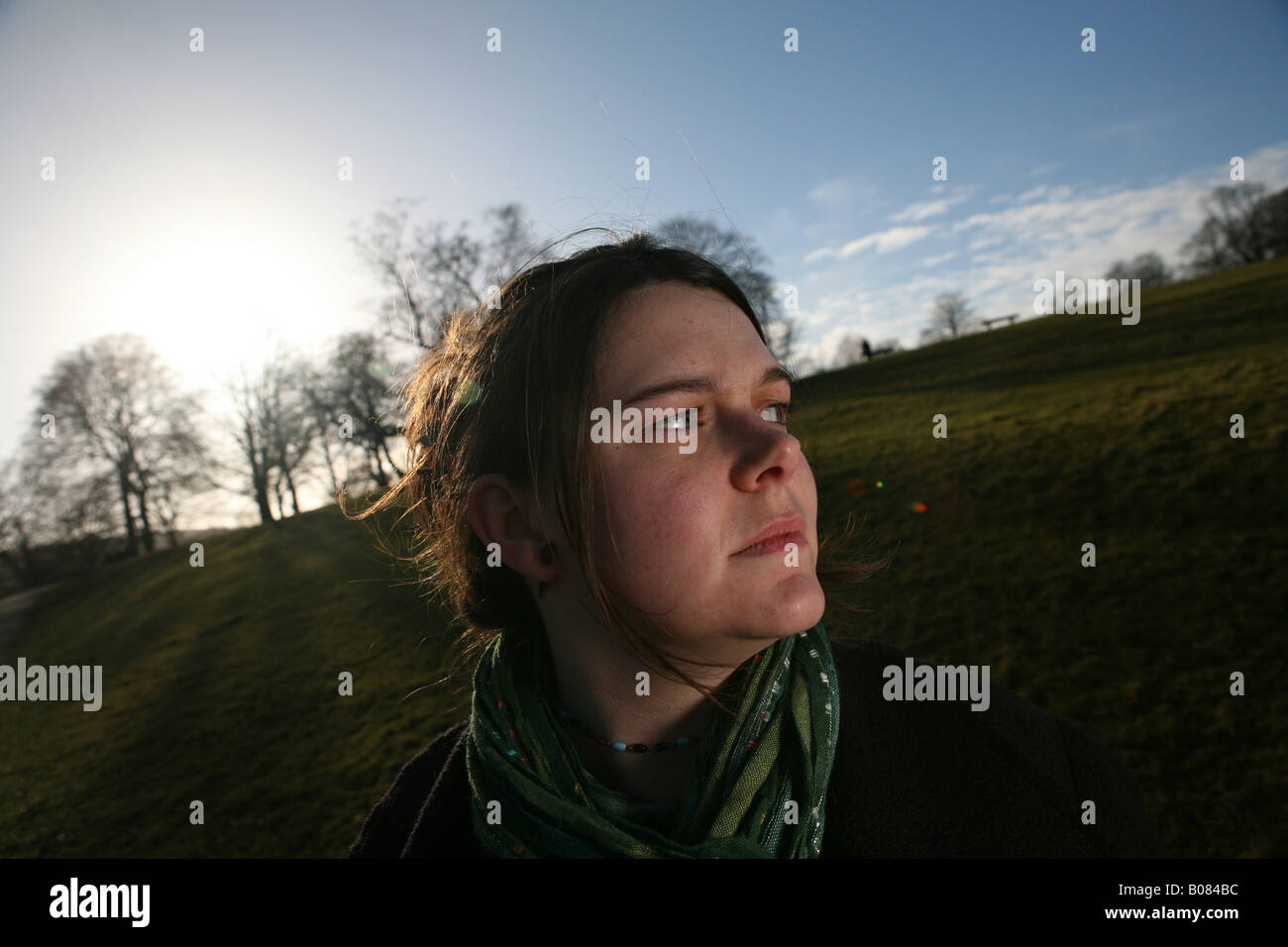 a portrait of a beautiful woman looking off camera with the camera ...