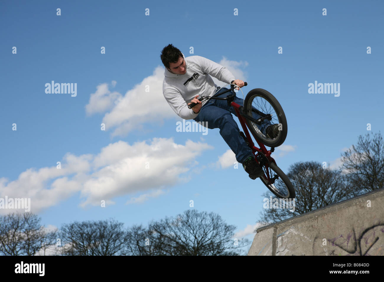 a man doing a trick on a bmx bike on a half pipe Stock Photo - Alamy