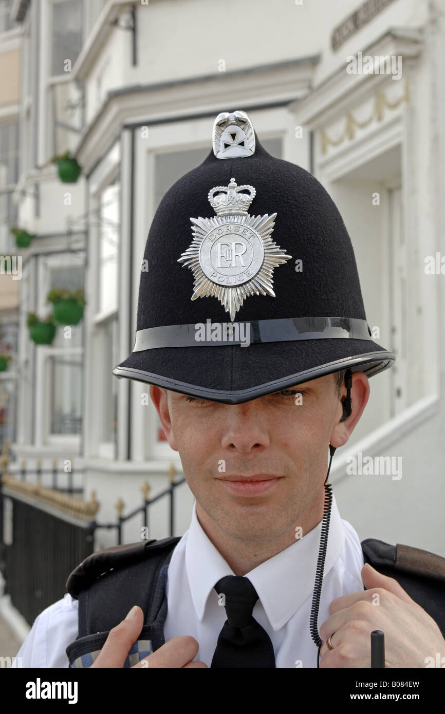 Portrait view of a British Police Officer wearing the traditional bobby ...