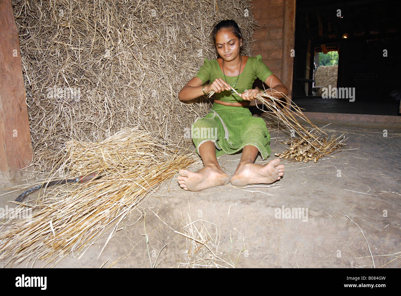 Warli Tribal women making rope Stock Photo - Alamy