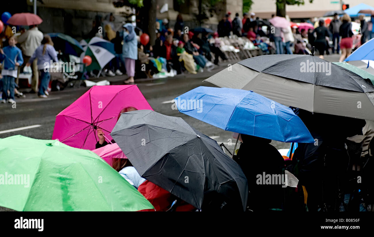Crowd waiting patiently for parade on rainy day Stock Photo - Alamy