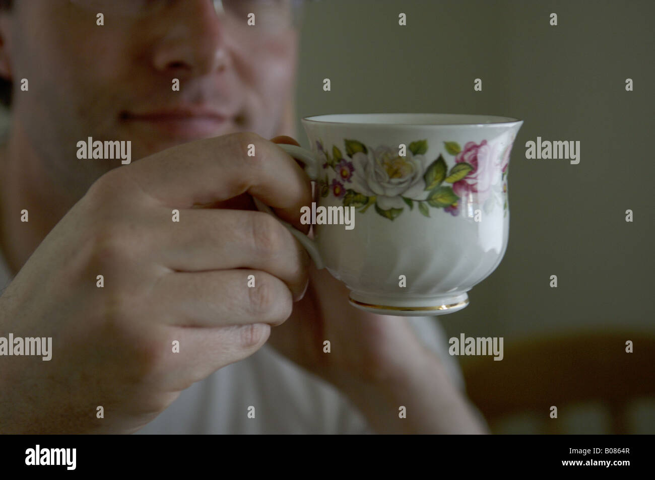 White English man holding a porcelain tea cup Stock Photo - Alamy