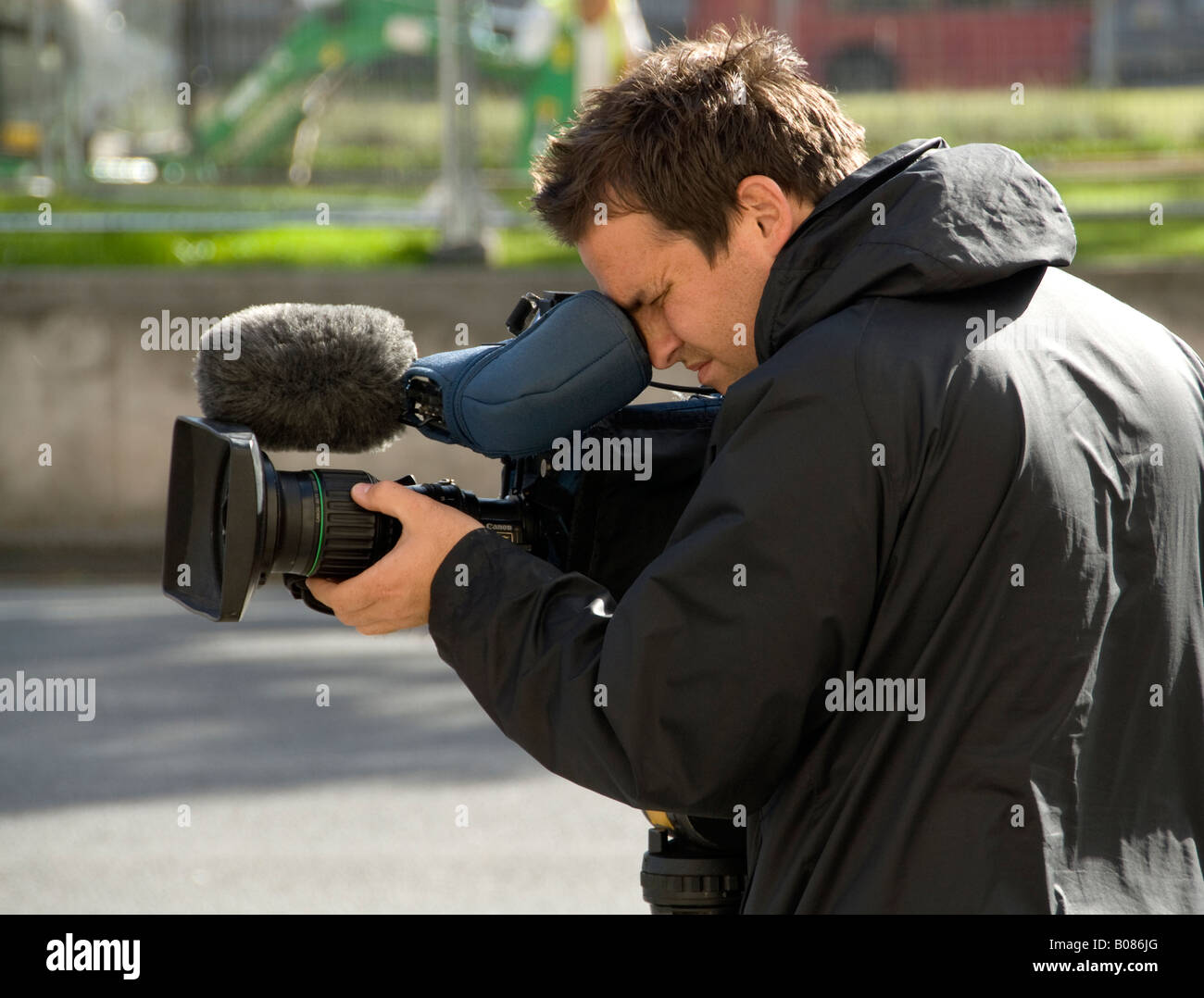Cameraman filming with a Canon video camera, London, England, UK, 2007 ...