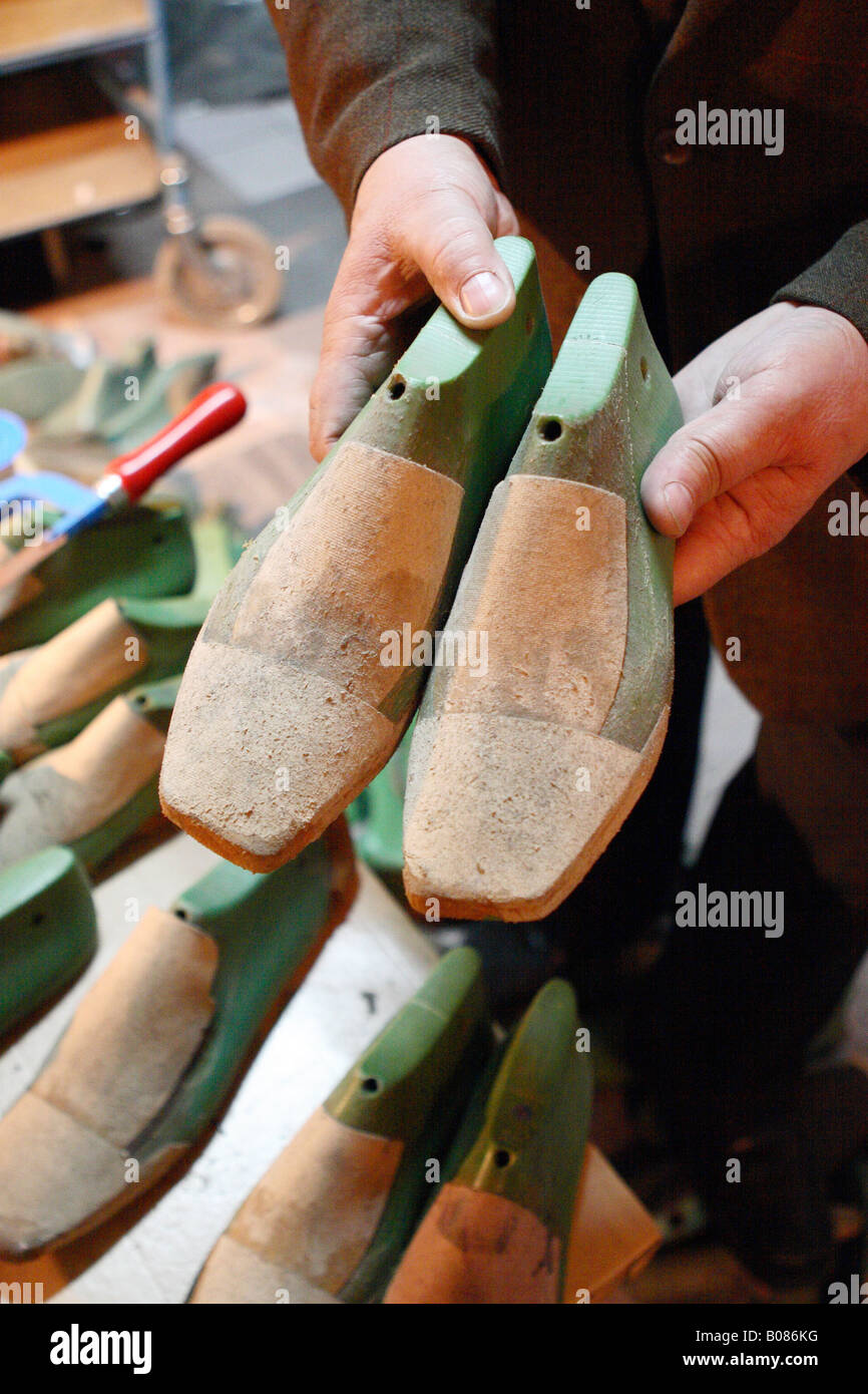 A bespoke shoemaker holds a pair of Lasts a type of mould used to make ...