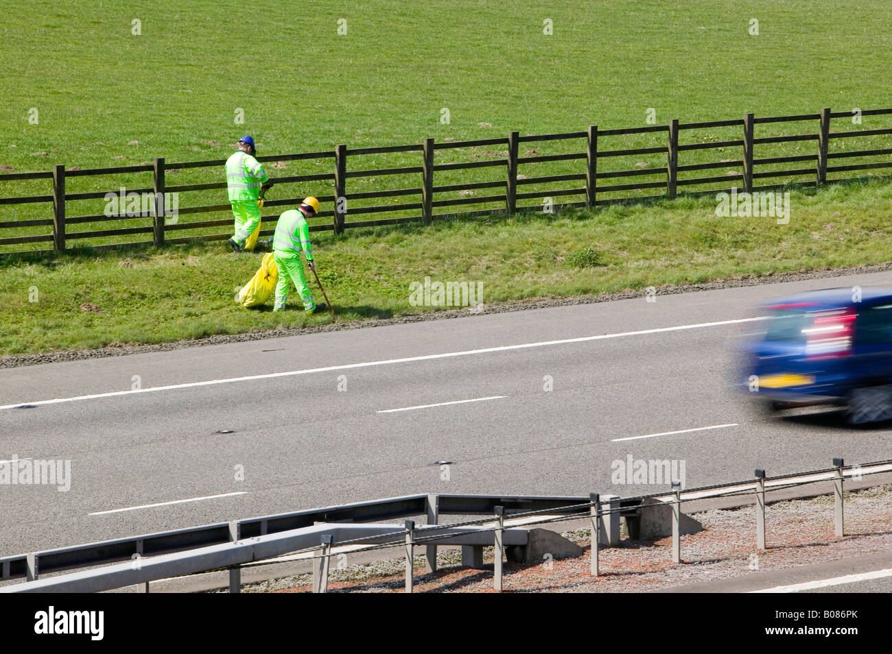Council workers litter picking on the side of the M74 motorway at ...