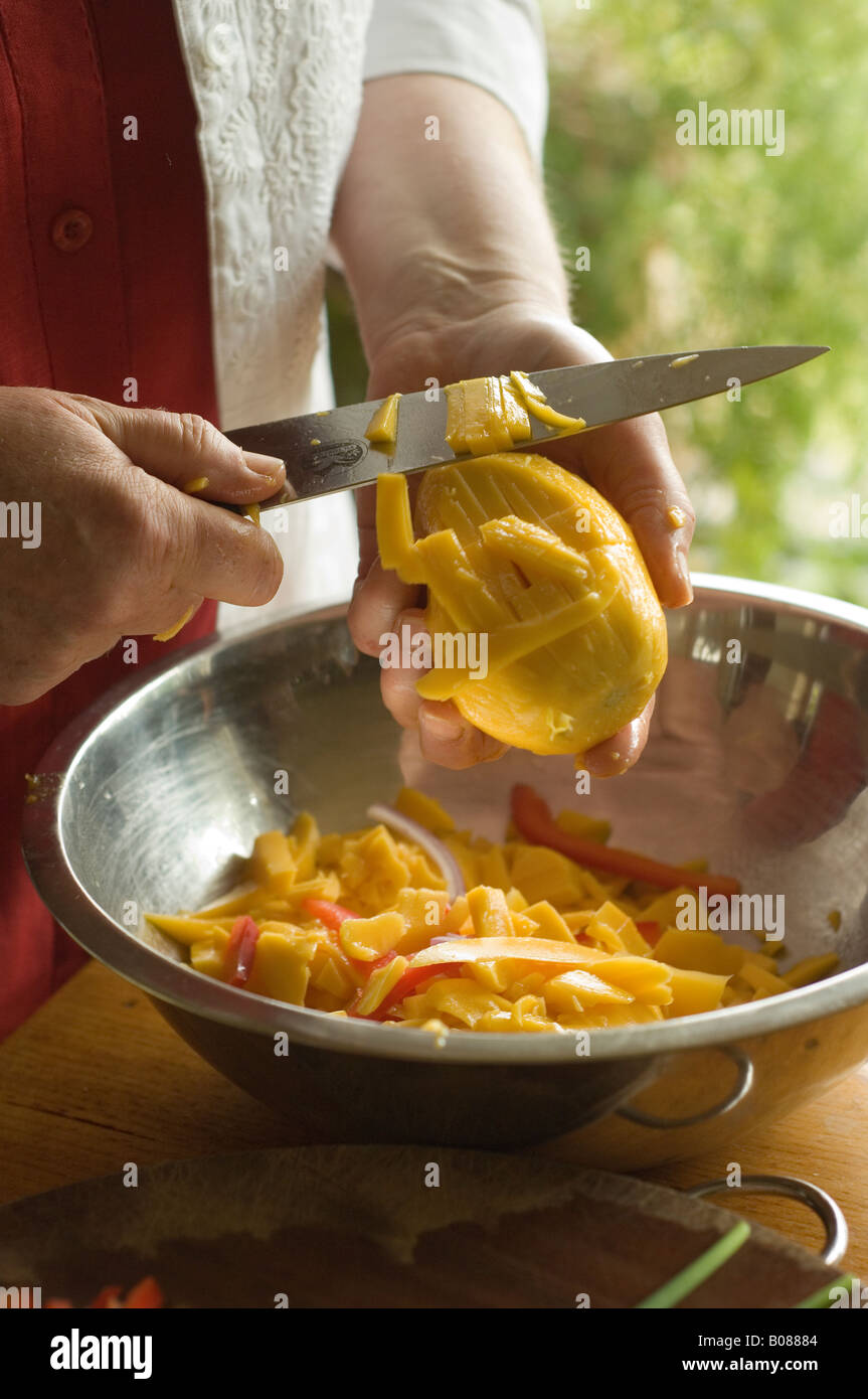 Cutting a mango for food preparation Stock Photo - Alamy