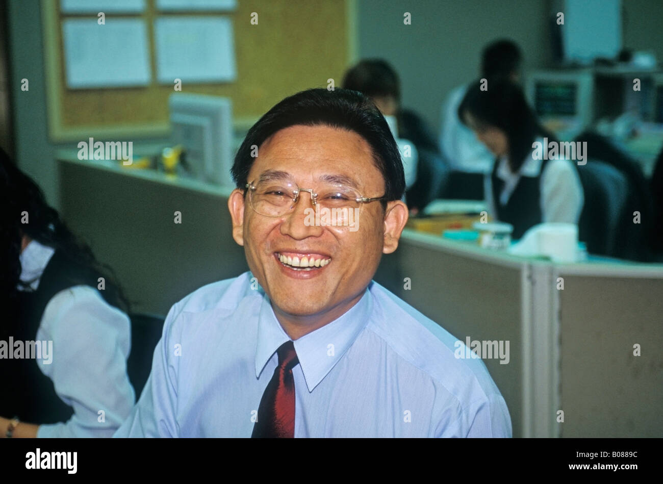 Asian Chinese Man Smiling At Work Stock Photo - Alamy