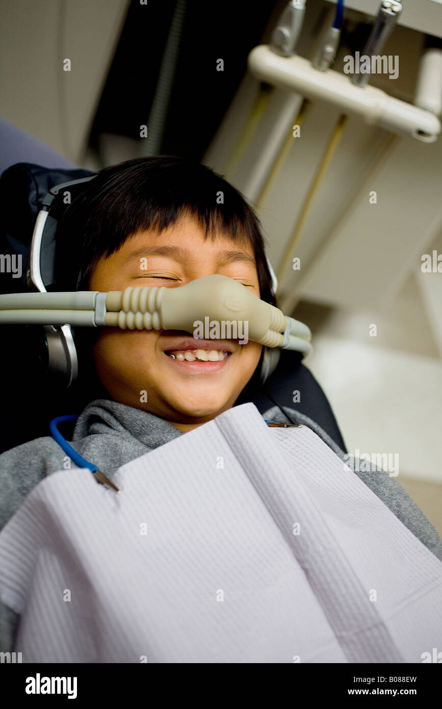 Dentist examining Asian boy's (9-10 years) teeth Stock Photo - Alamy