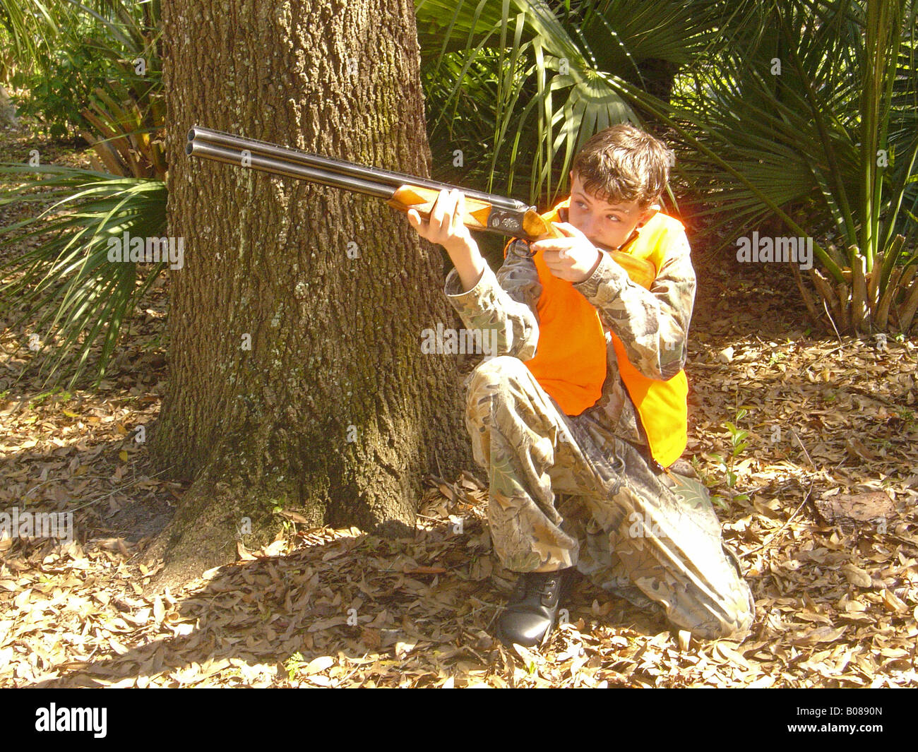 Boy shooting rifle Stock Photo - Alamy