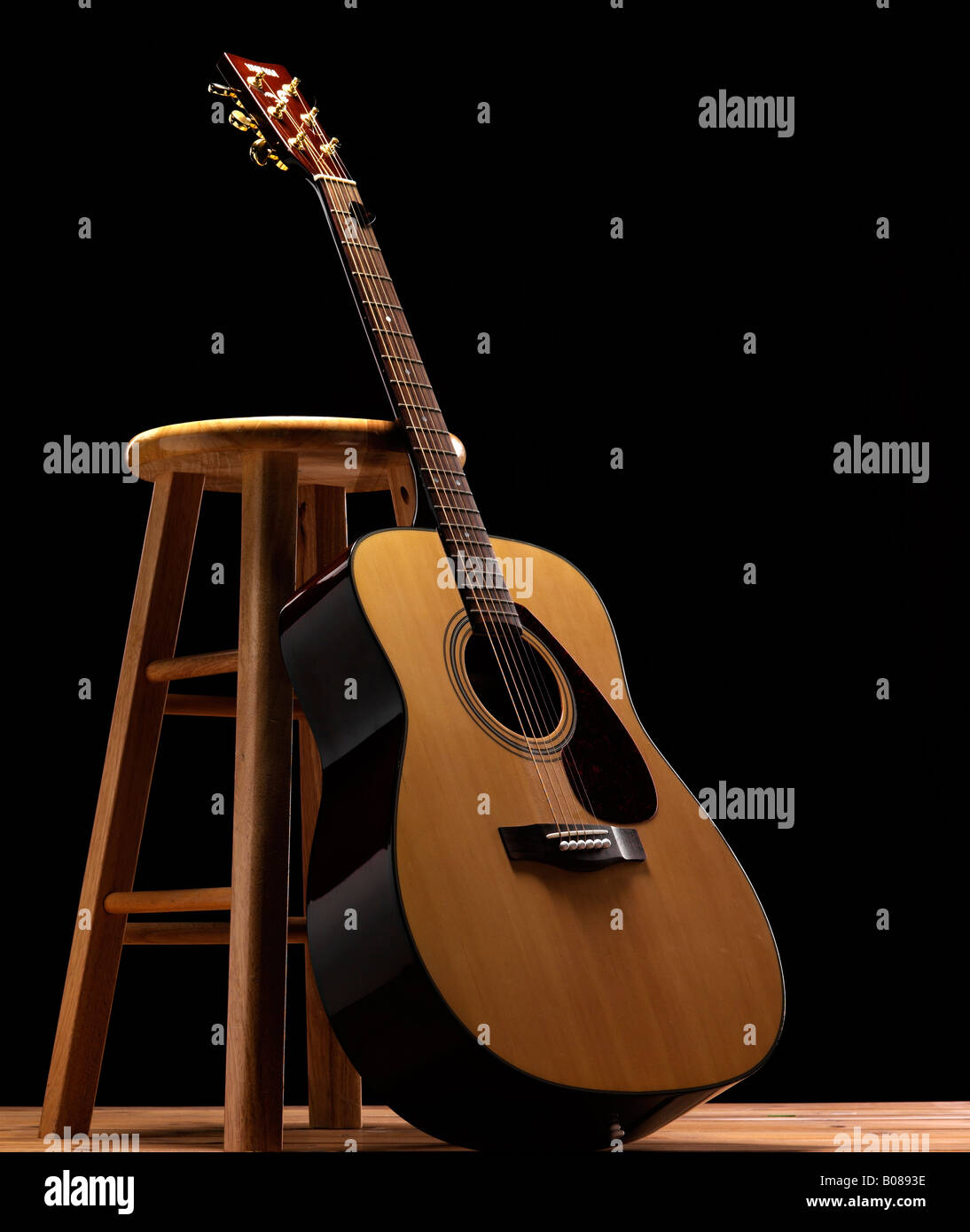guitar on stage leaning against stool taken in studio Stock Photo - Alamy