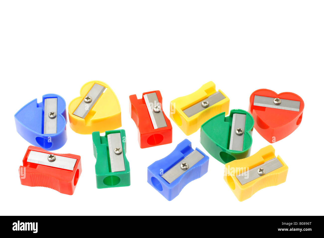 Colorful pencil sharpeners arranged on white background with copy space ...