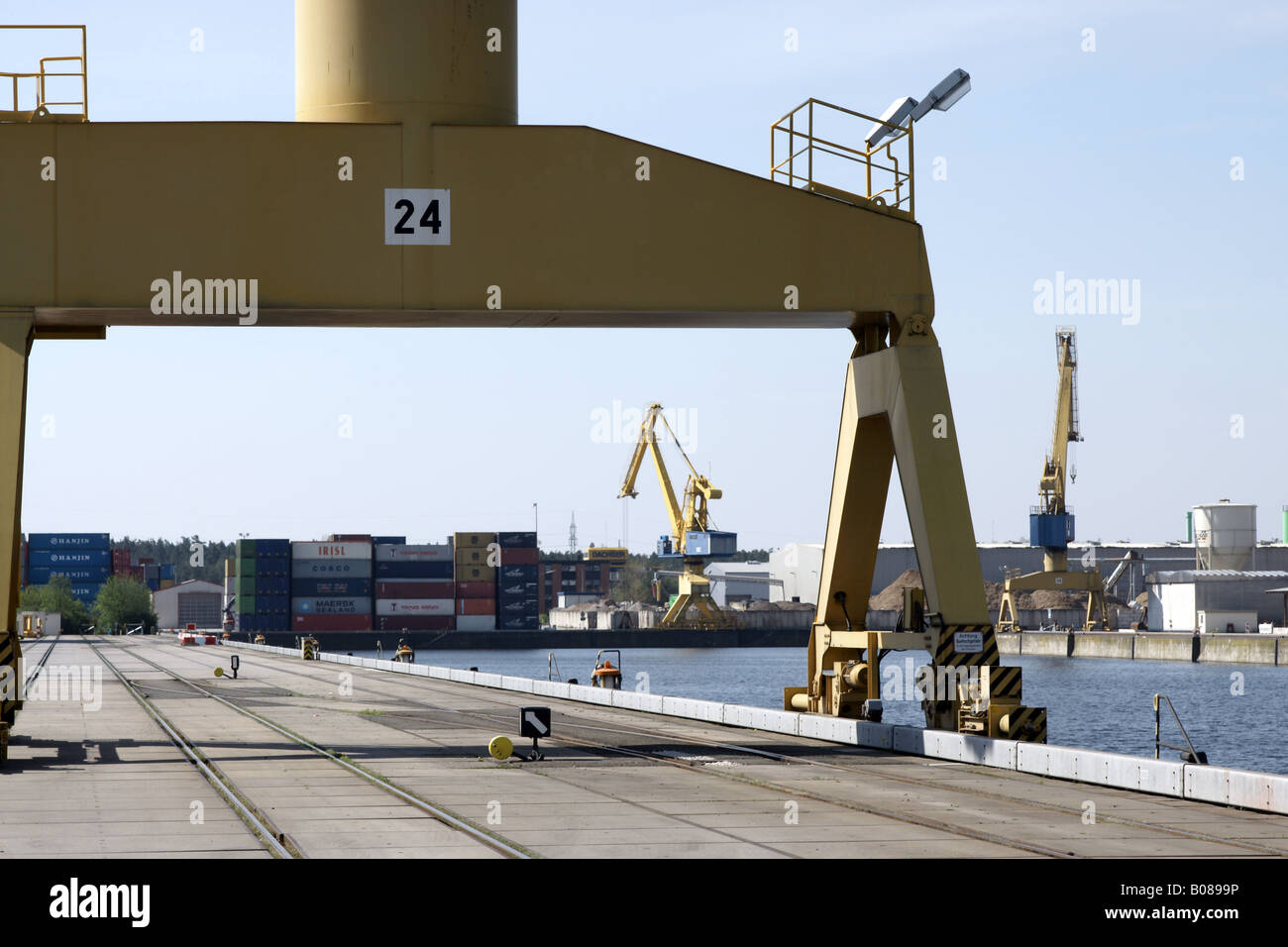 Stacks of cargo containers with yellow crane / Frachtcontainer mit Kran ...