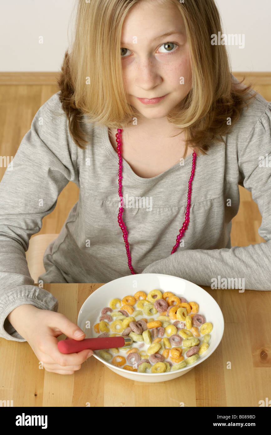 Girl eating cornflakes Stock Photo - Alamy