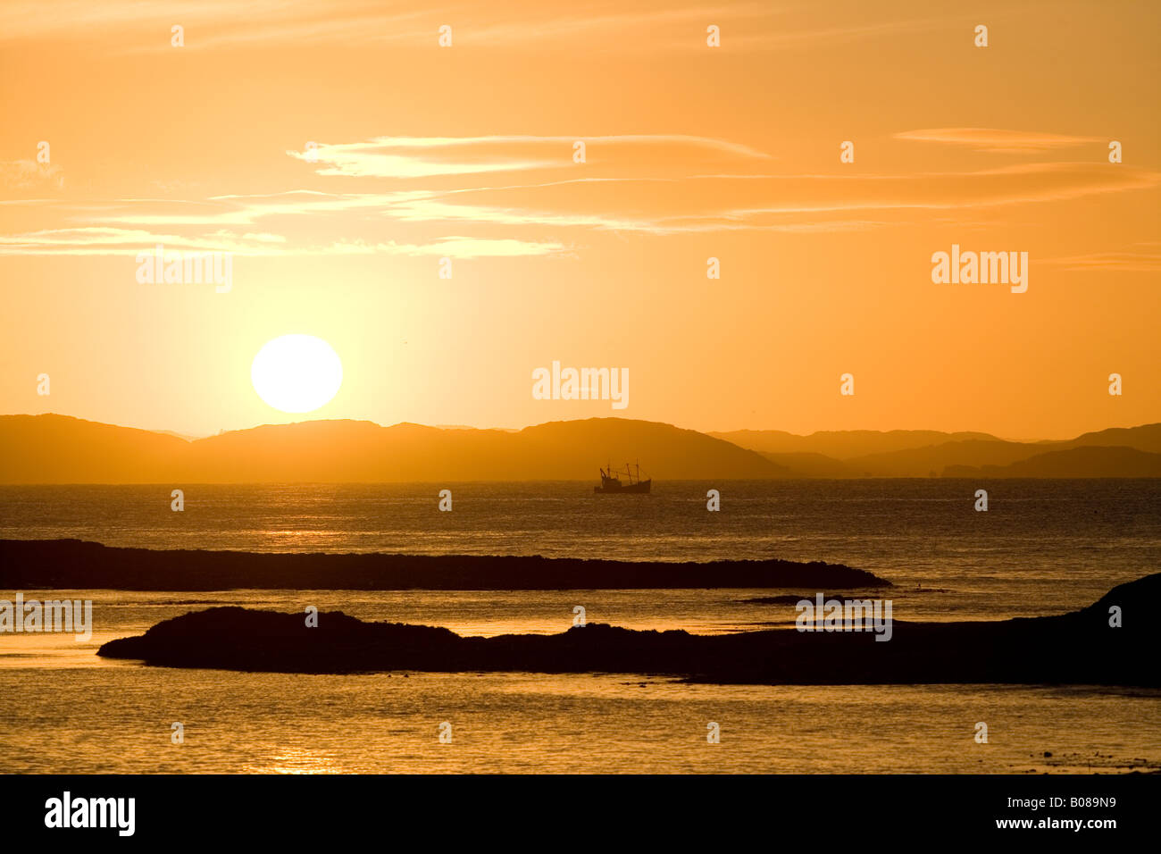 Sun rising over Garvellach Islands viewed from Carsaig Bay, Isle of ...