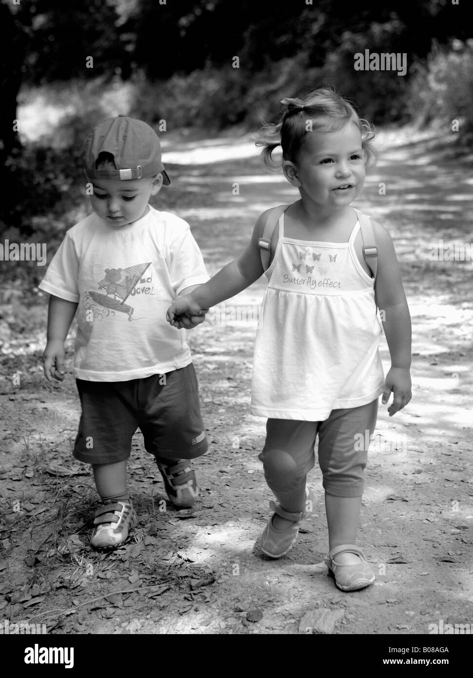 Two young friends walk together along a country path Stock Photo - Alamy