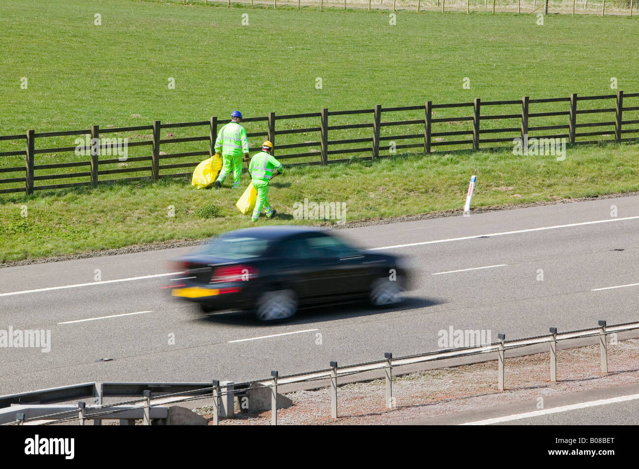 Council workers litter picking on the side of the M74 motorway at ...