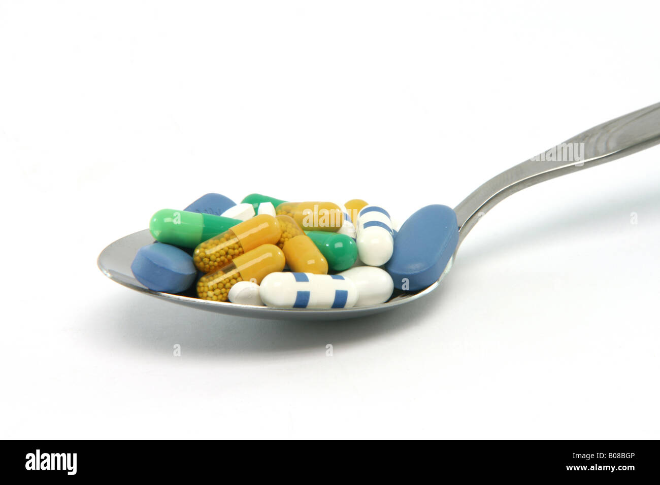 spoon full of pills isolated on white background health amd medical ...