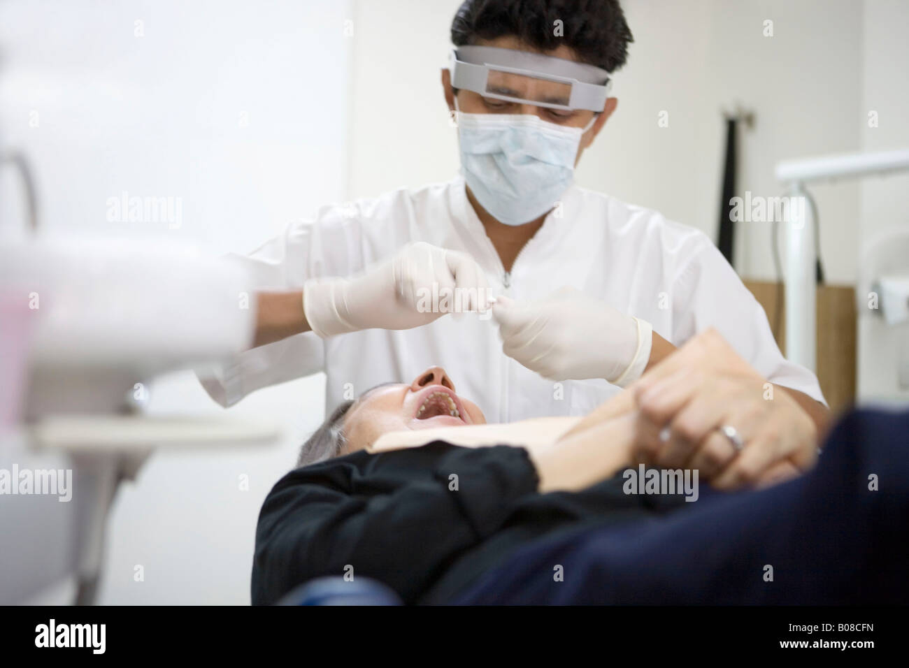 Dentist performing an examination Stock Photo - Alamy