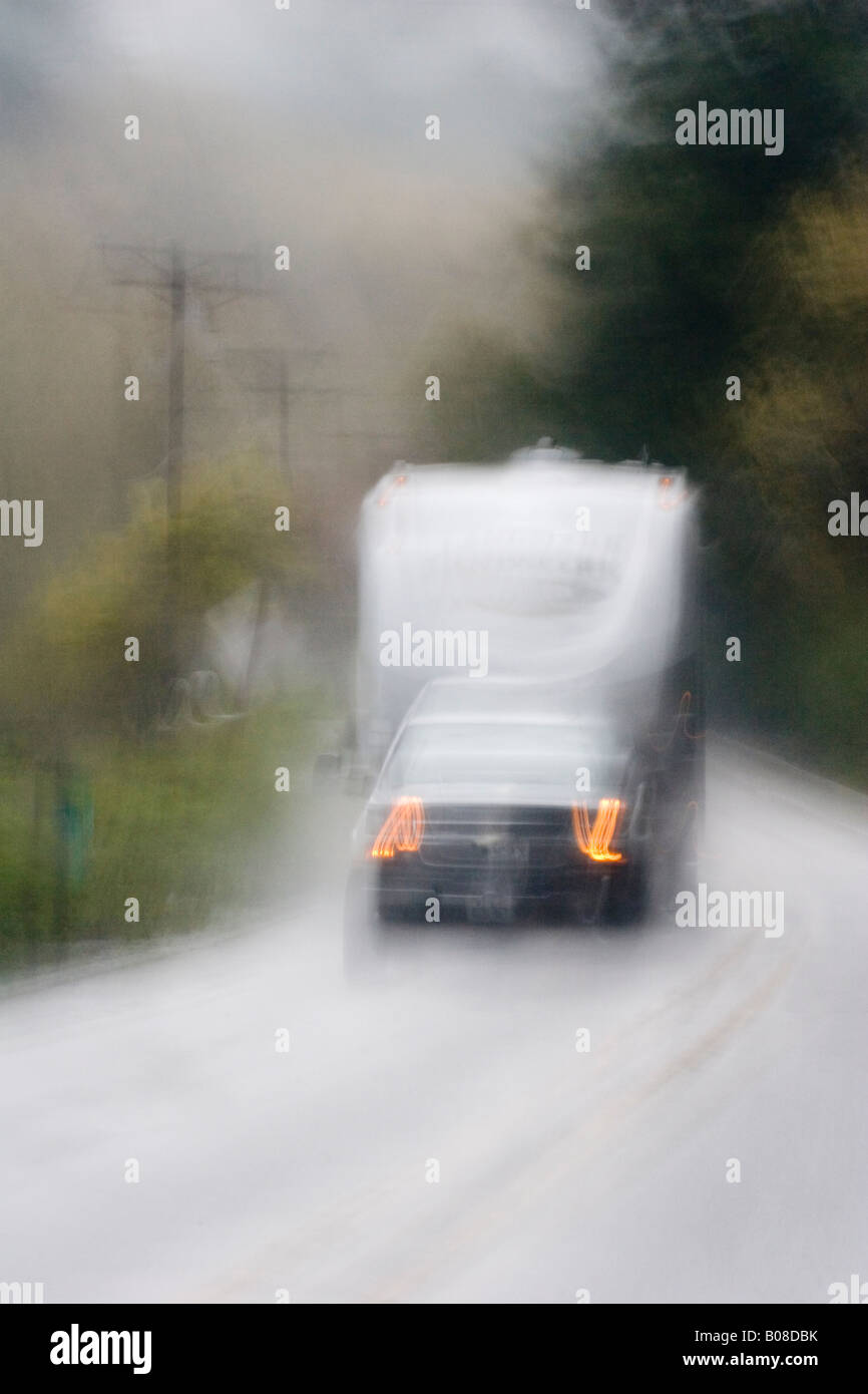 Glimpse of oncoming car and camper on rainy road Stock Photo - Alamy