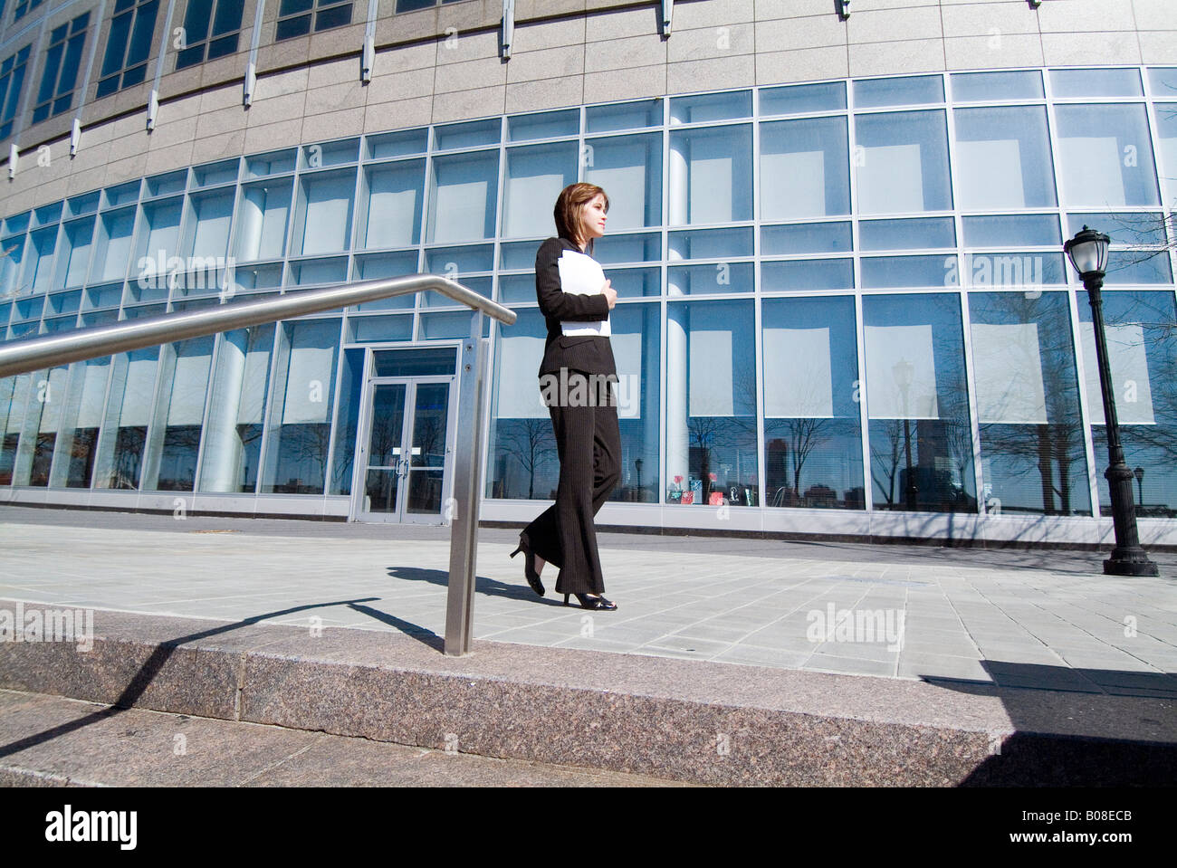 Office worker in front of building Stock Photo - Alamy