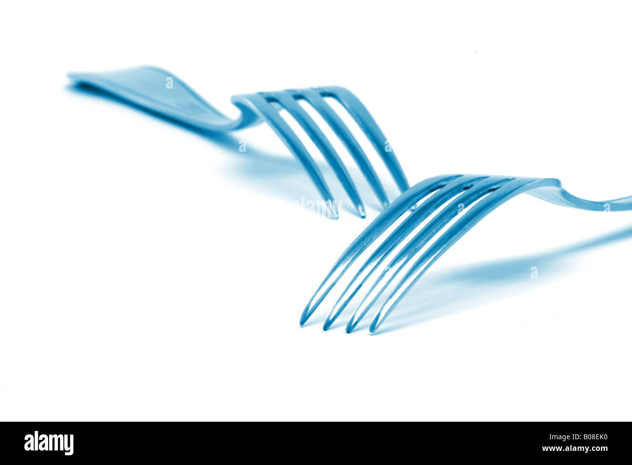 two blue color forks isolated on white background food industry ...