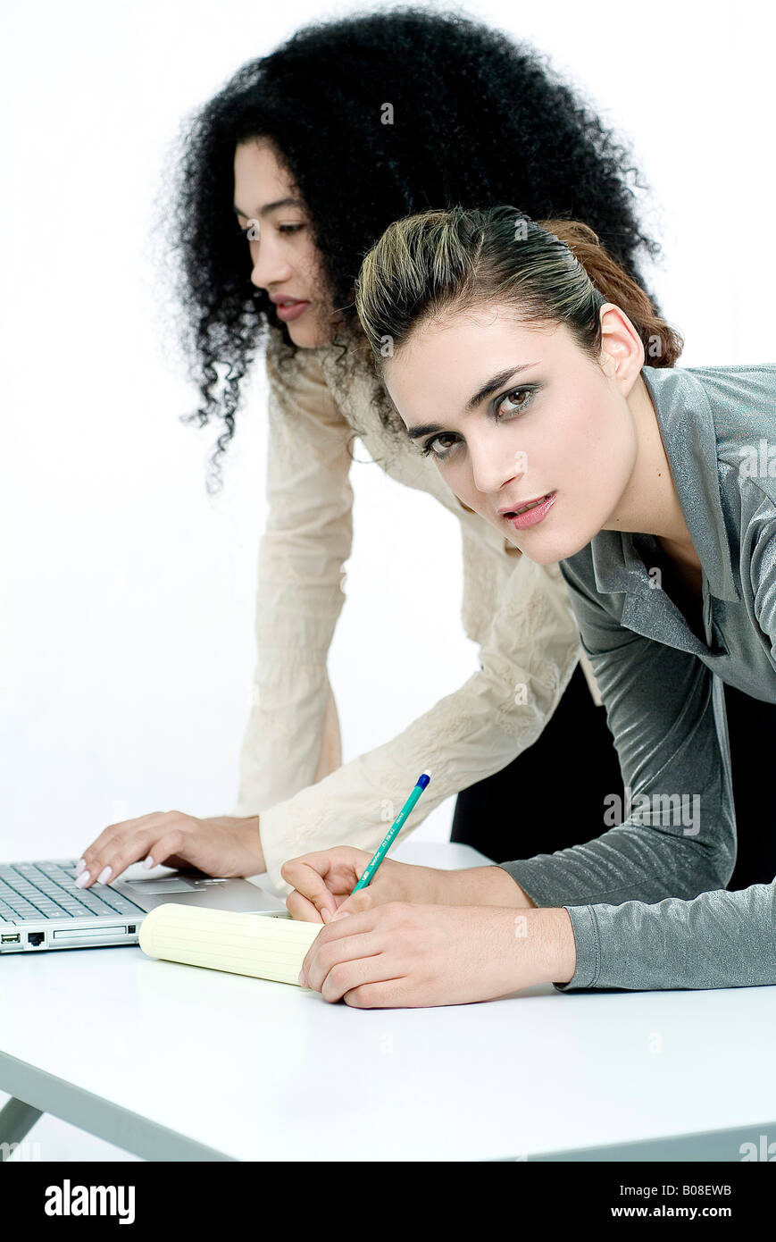 Two women in office by desk Stock Photo - Alamy