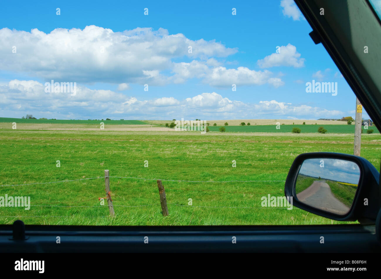 Blue green landscape from driving seat out of the offside car window ...