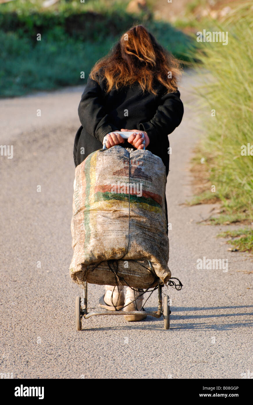 Old lady pulling trolley hi-res stock photography and images - Alamy