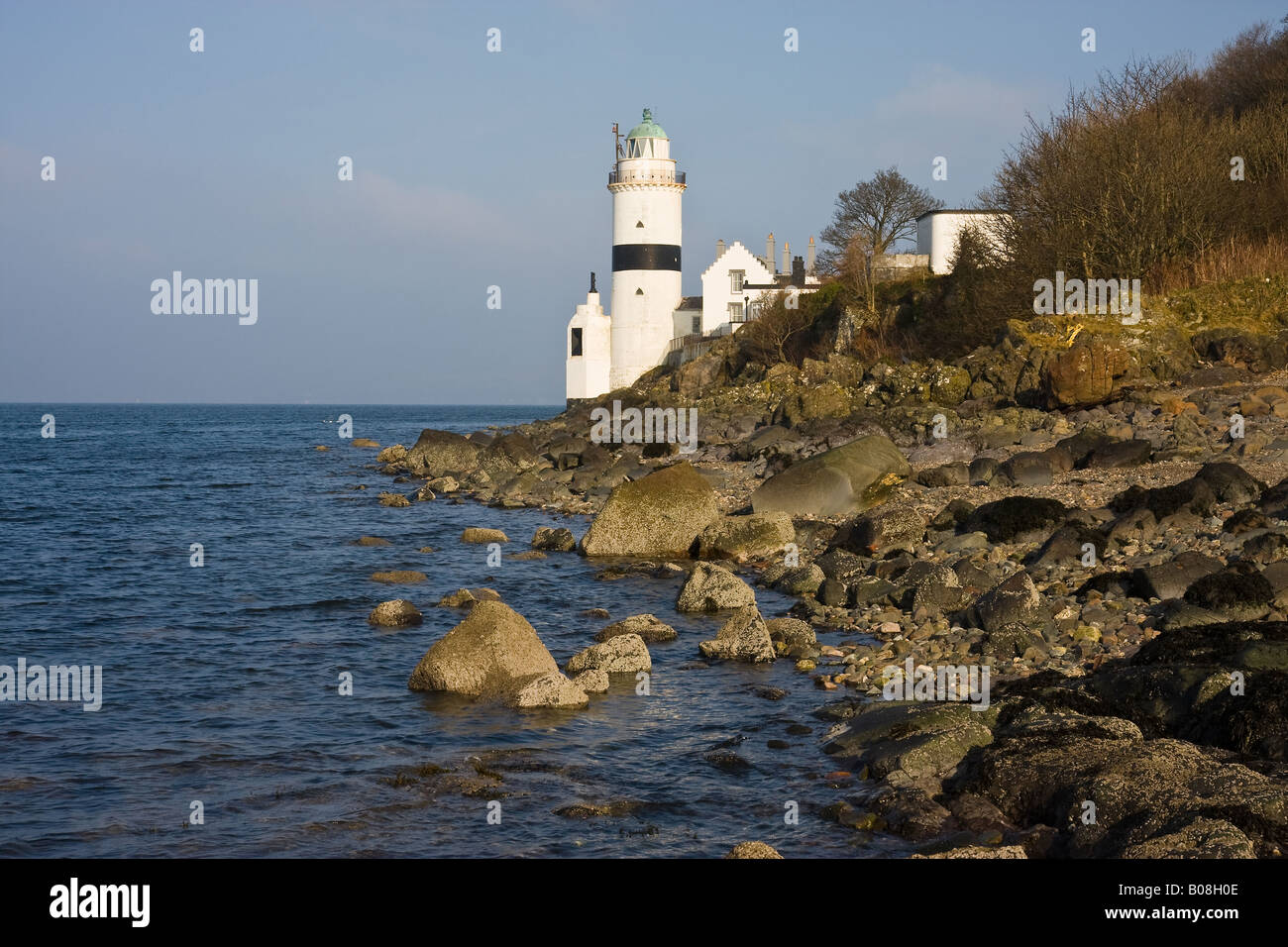 An afternoon view of a typical Scottish lighthouse on the shores of the ...