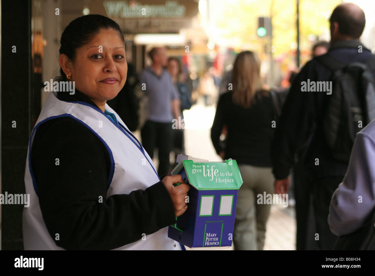 Woman charity collector on the street Stock Photo - Alamy