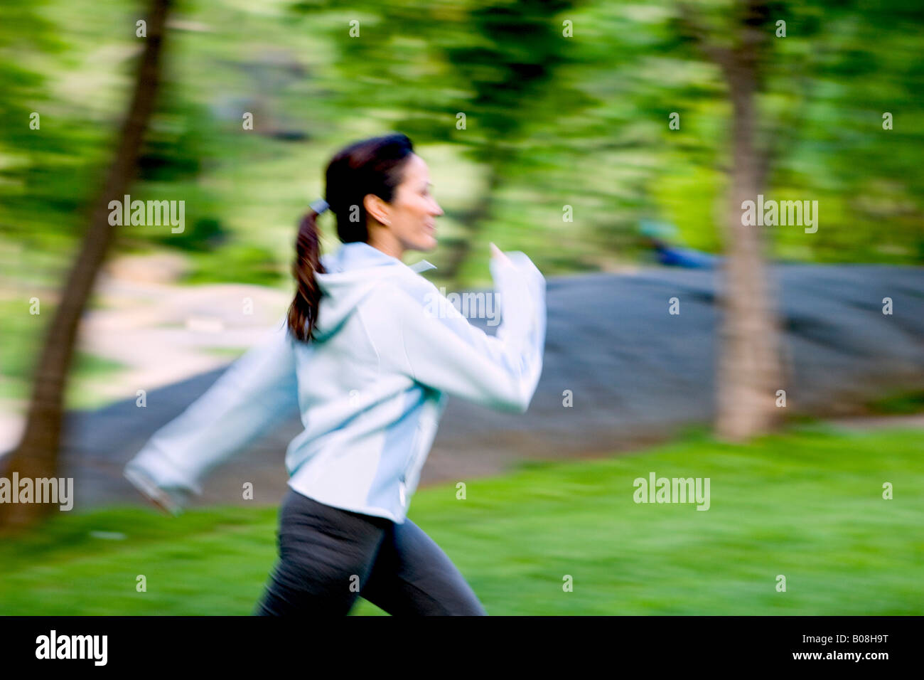 Woman speed walking at the park Stock Photo - Alamy