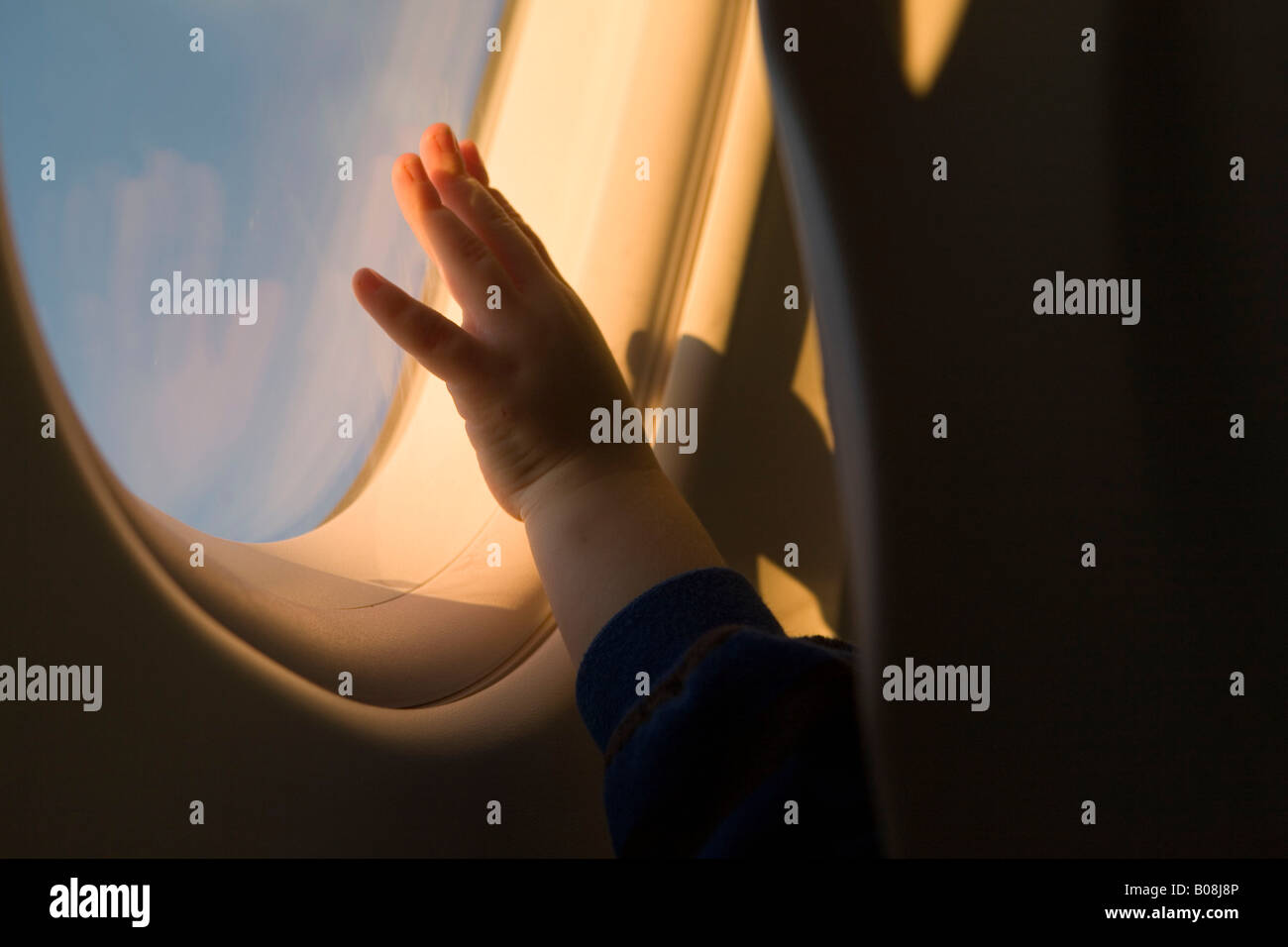 Boy touching airplane window Stock Photo - Alamy