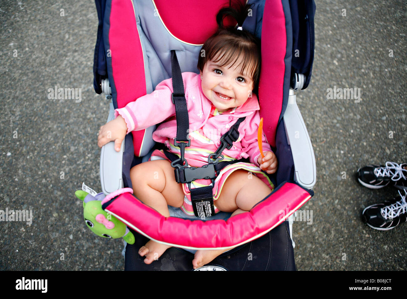 Baby girl in stroller Stock Photo - Alamy