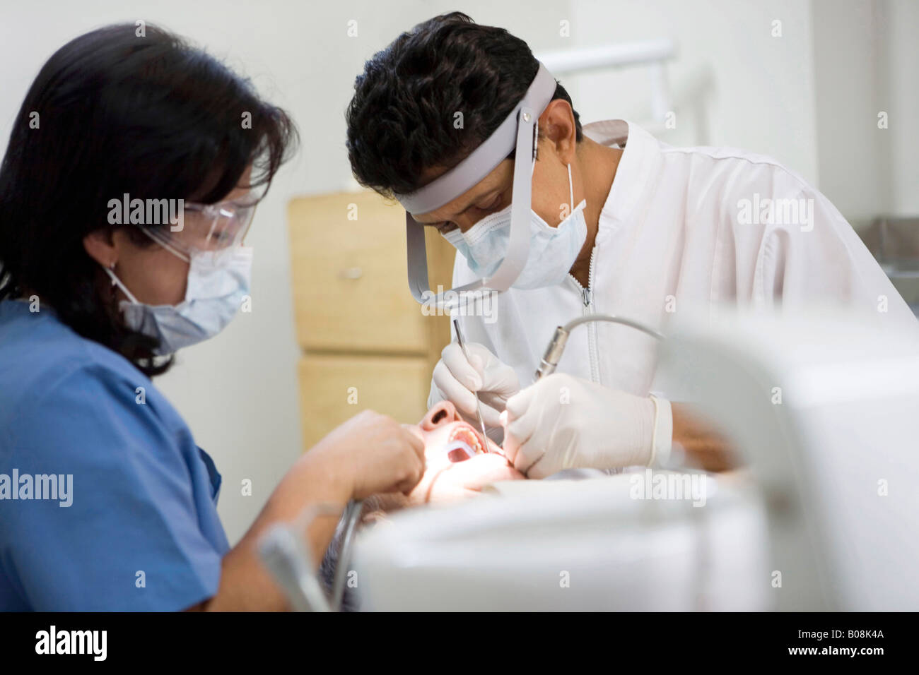 Dentist performing examination with medical assistant Stock Photo - Alamy