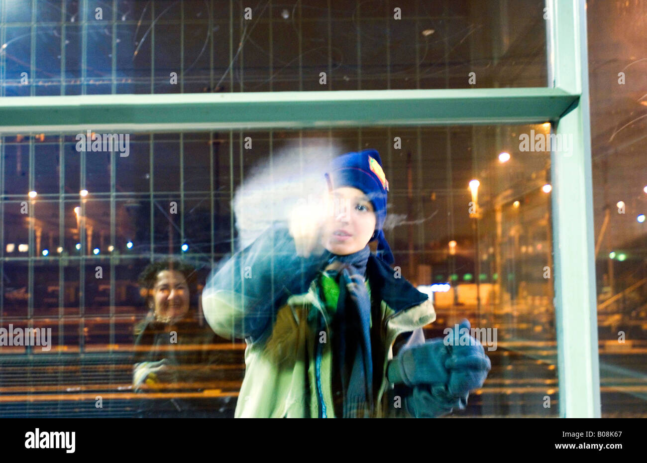 Young boy frost carving on glass Stock Photo - Alamy