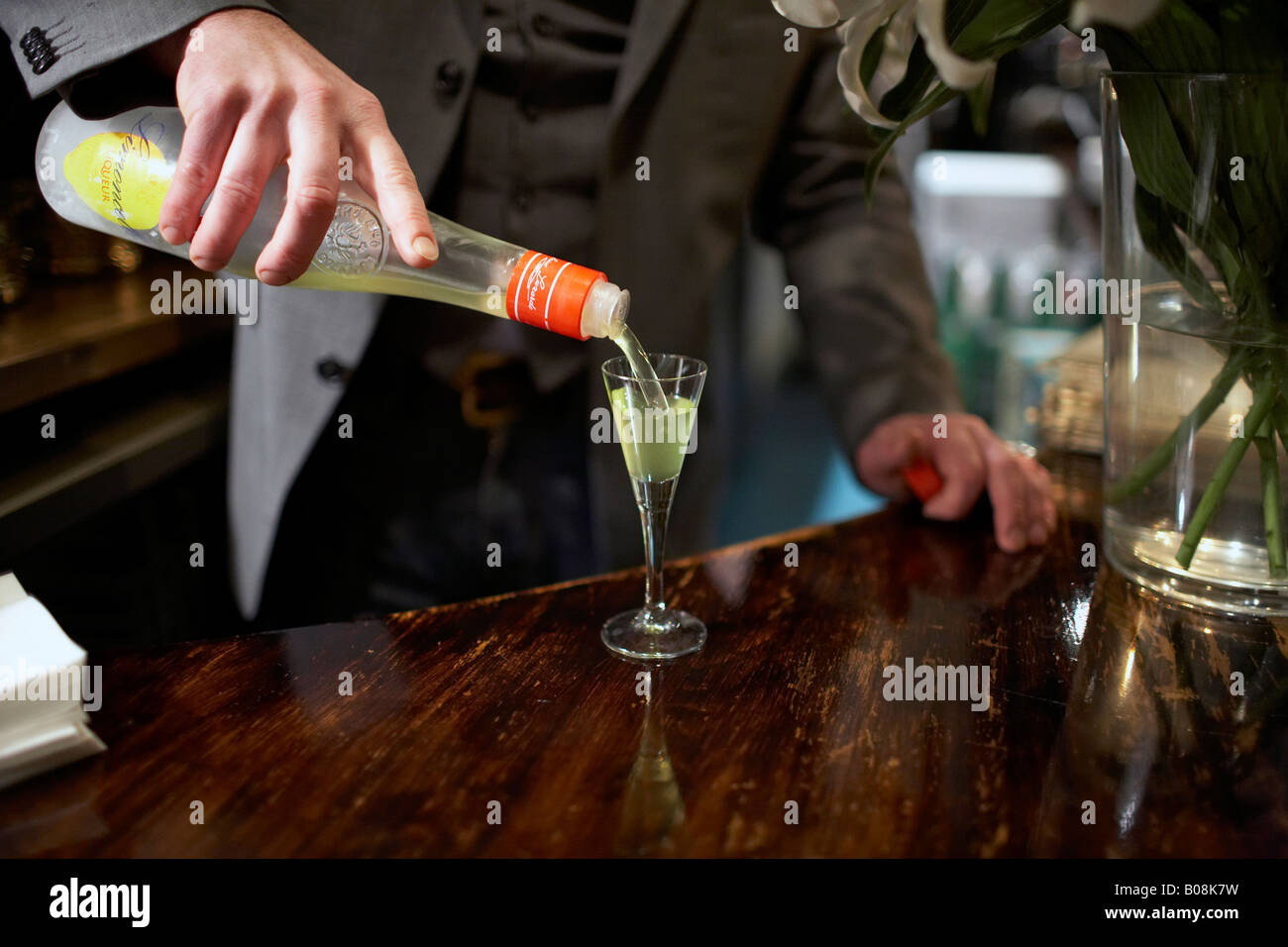 Italian lemon liqueur Limoncello being poured into crystal glass Stock ...