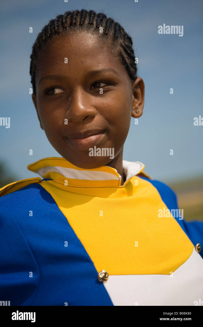 Teenage girl in marching band uniform during a break in the parade ...