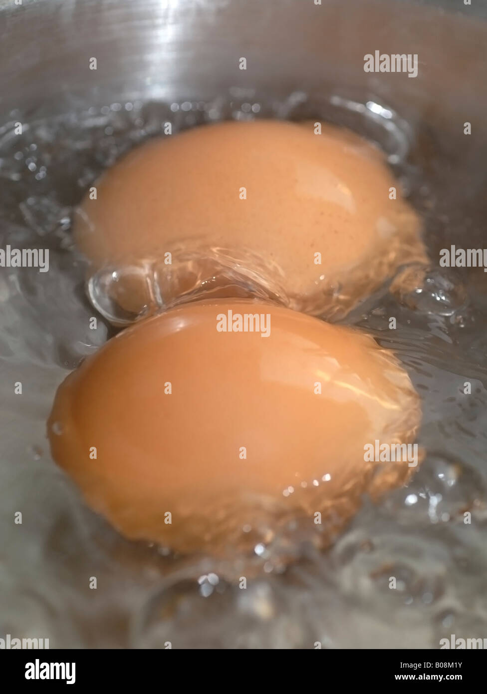 Eggs Boiling in Water Stock Photo - Alamy