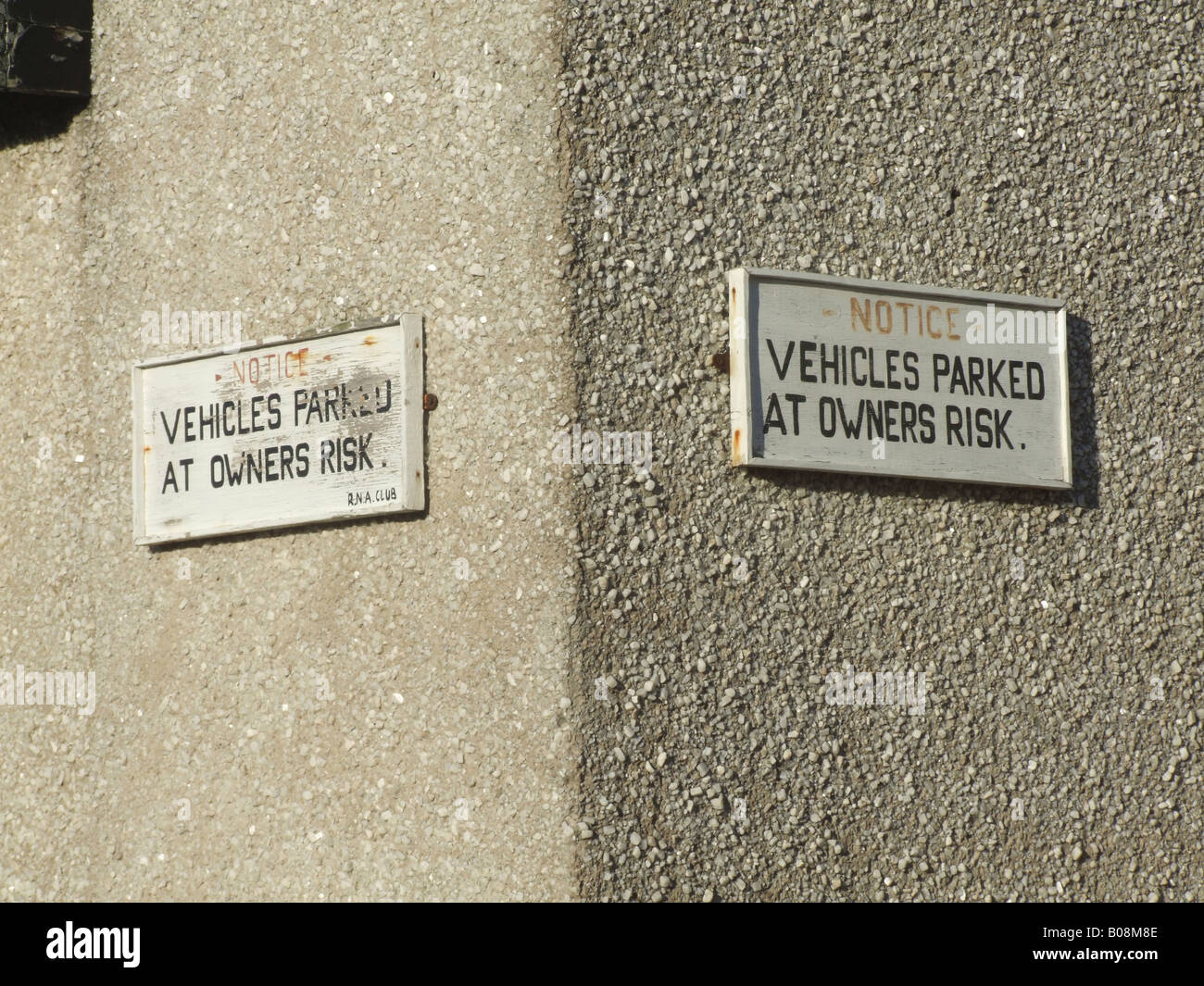 parking at own risk sign in car park Stock Photo - Alamy