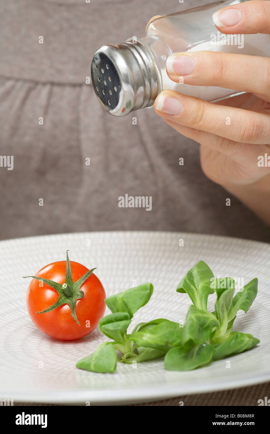 Woman salting dinner hi-res stock photography and images - Alamy