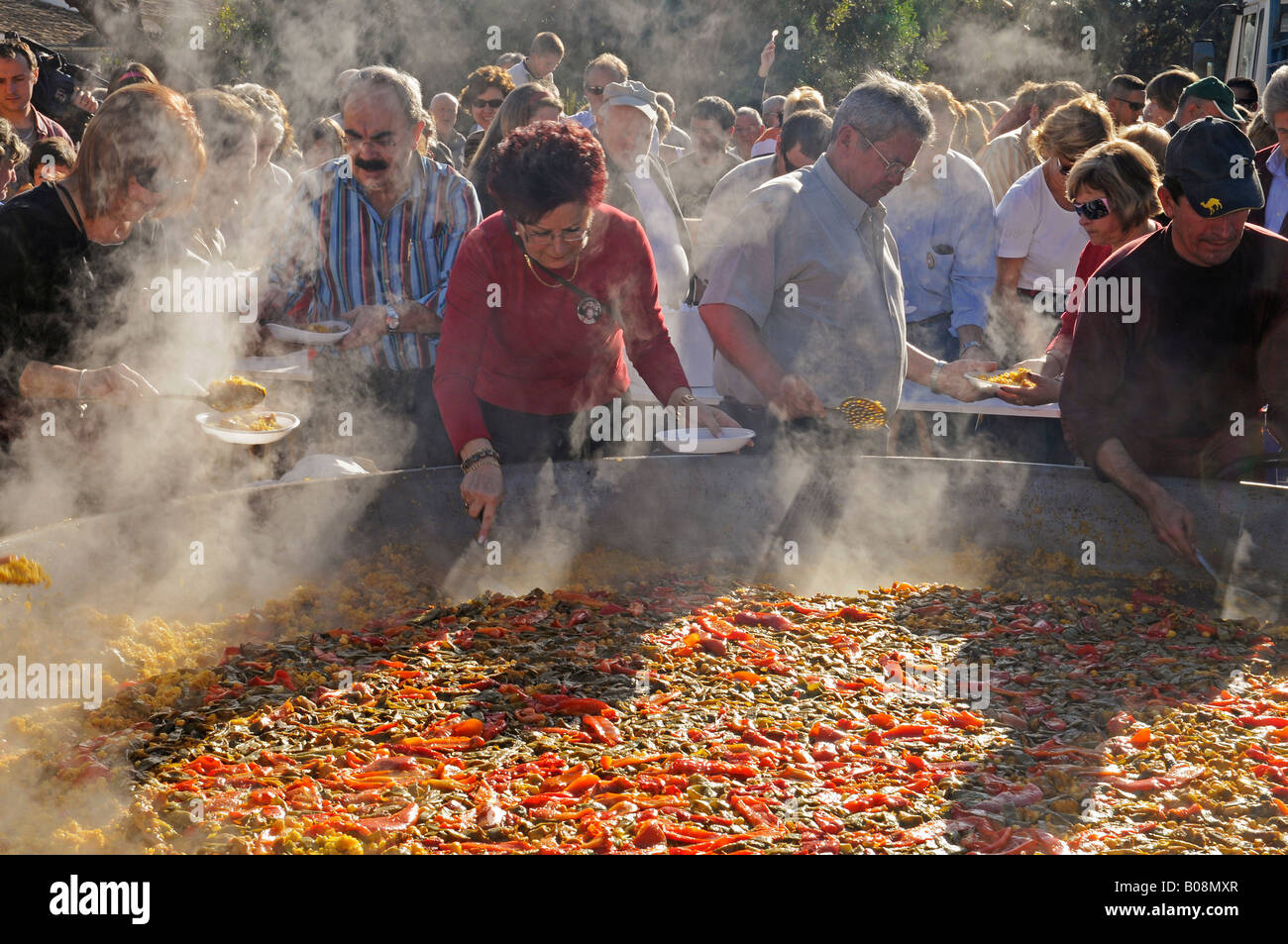 Crowd gathered around a huge vat of paella during fiesta, Altea la ...